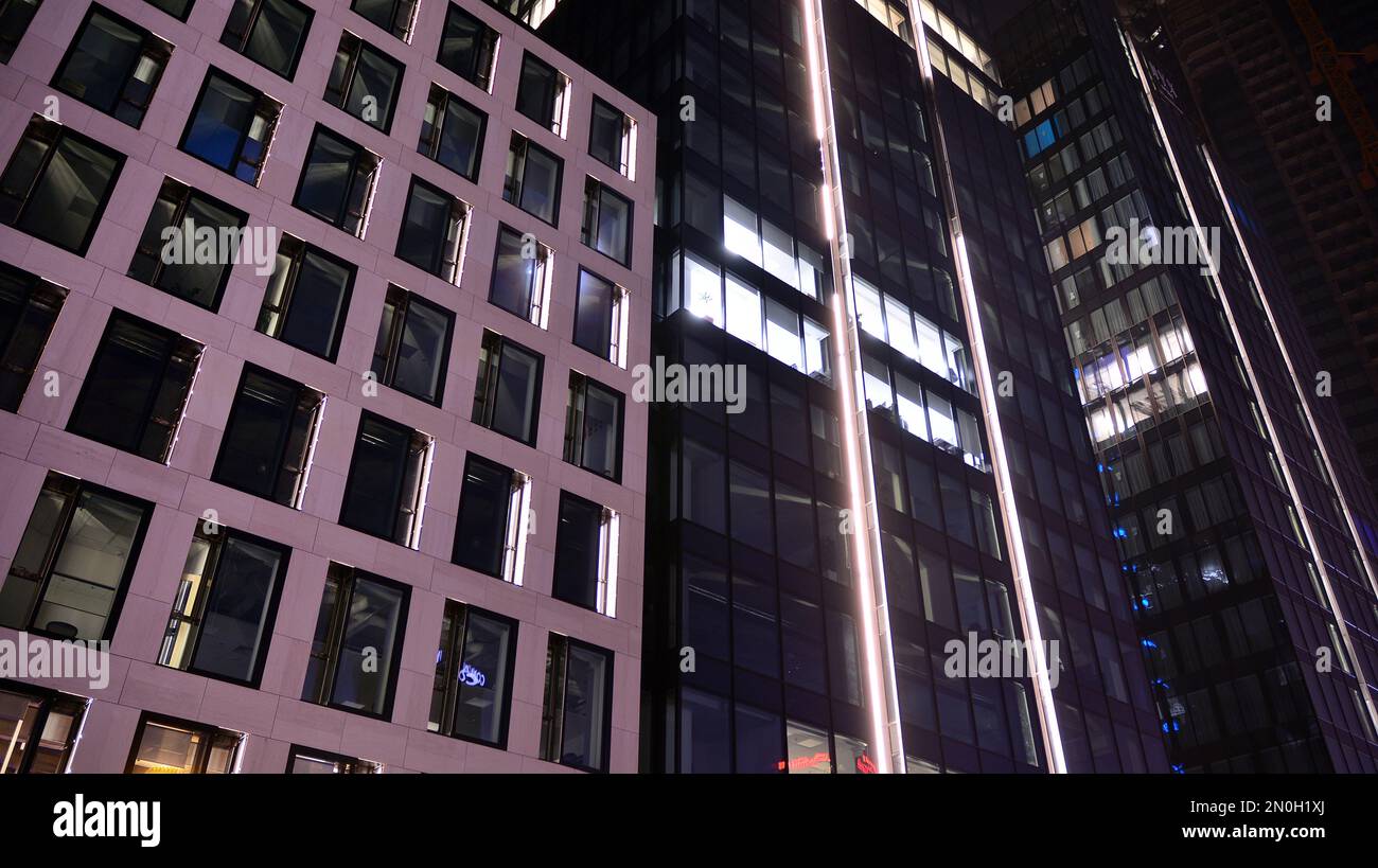 Pattern of office buildings windows illuminated at night. Lighting with ...