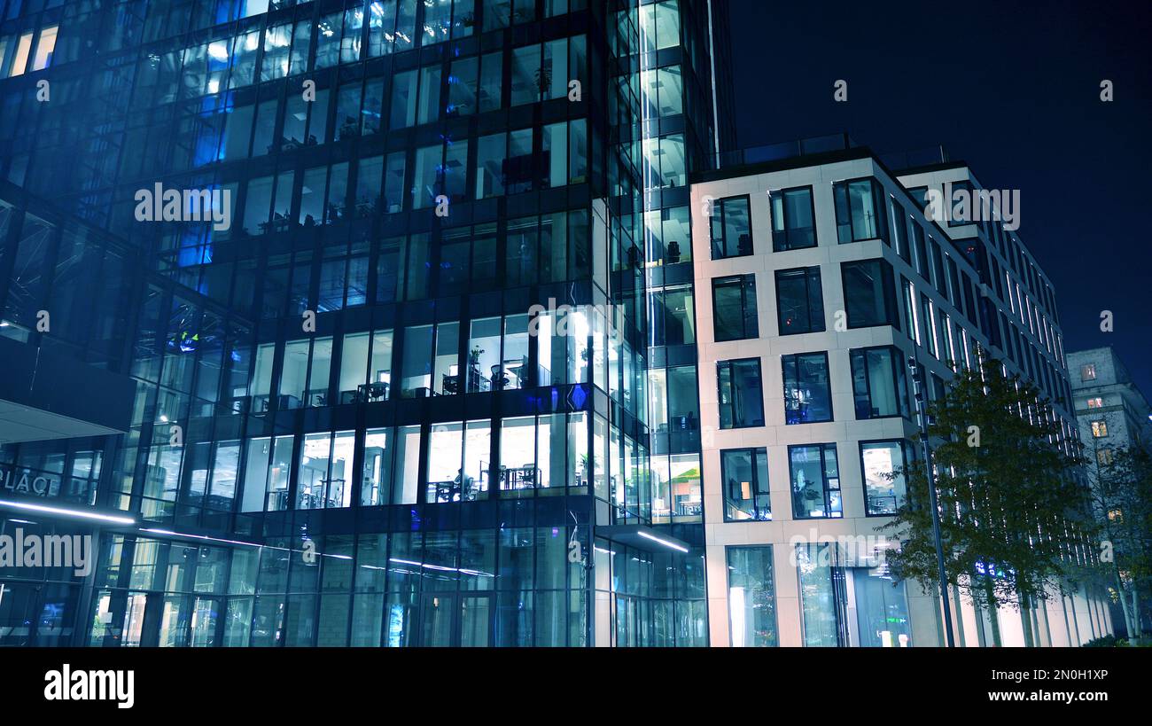 Pattern of office buildings windows illuminated at night. Lighting with ...