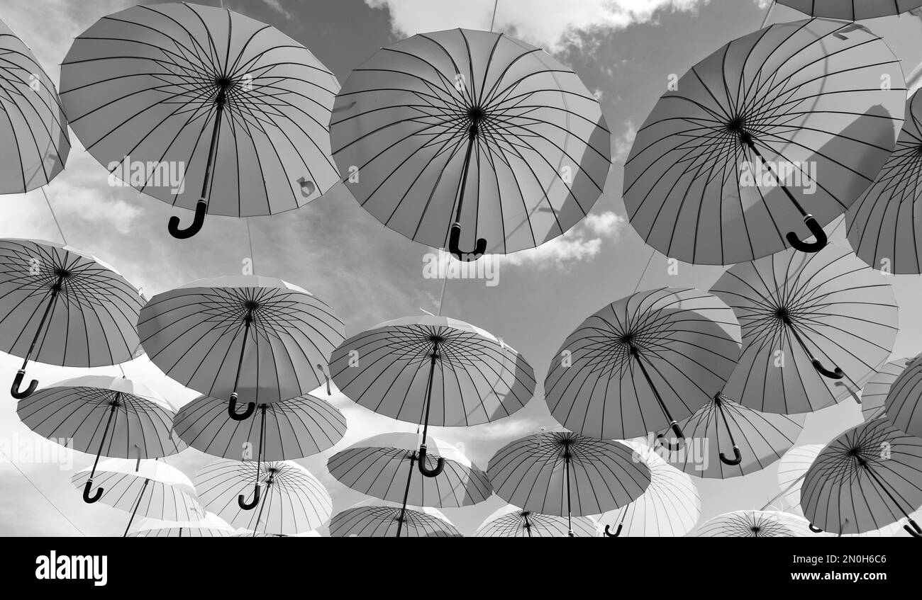 Blue and yellow umbrellas hanging in sky bottom- up. Umbrella ...