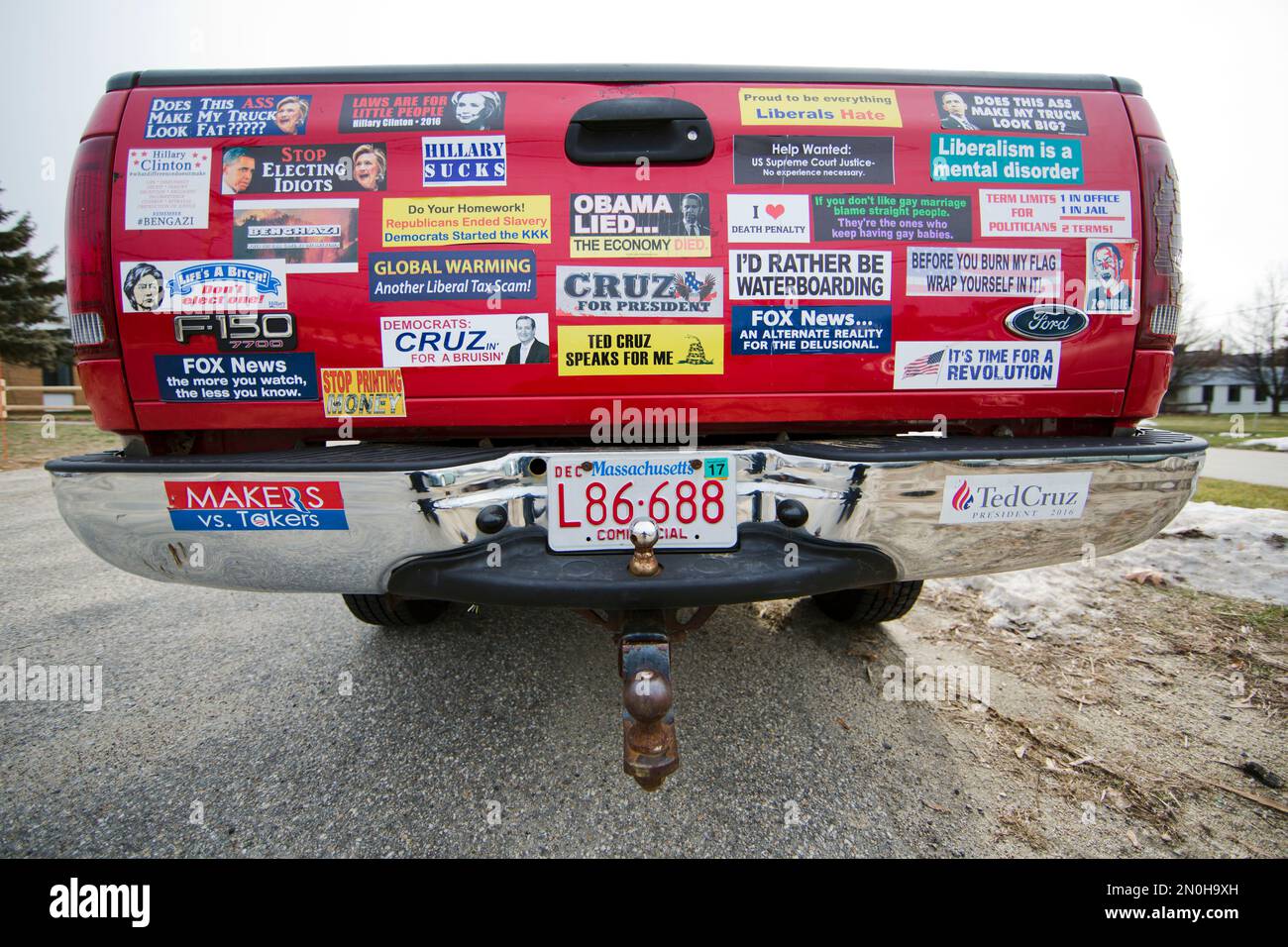Bumper sticker are affixed on the tailgate of an attendee at a campaign ...