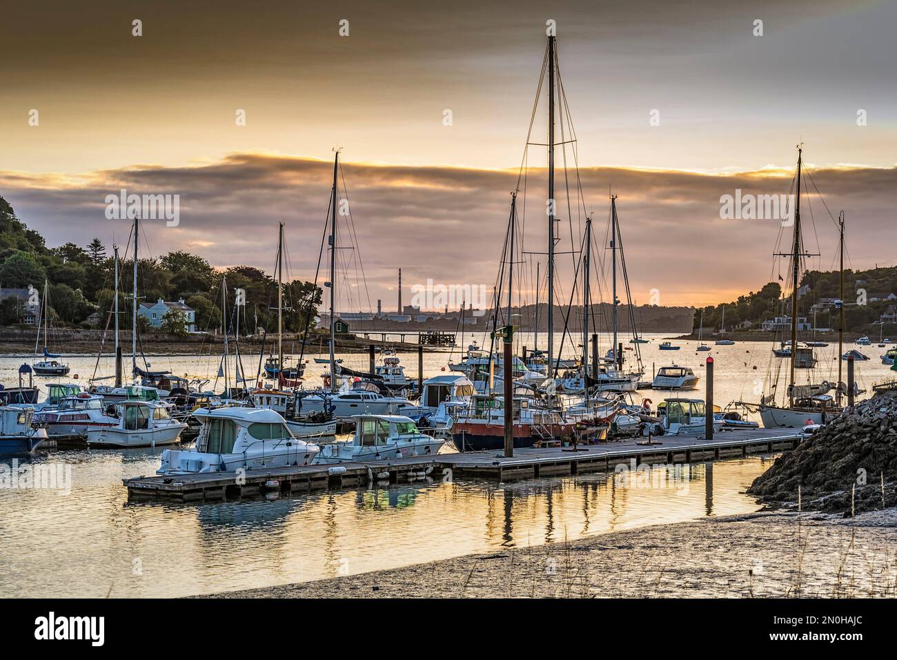 Colourful summer sunrise in the marina at Owenabue river estuary with ...