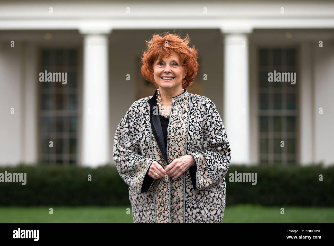 Sue Ellen Allen of Scottsdale, Ariz., poses for photographs in front of ...