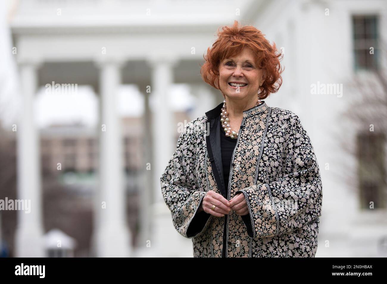 Sue Ellen Allen of Scottsdale, Ariz., poses for photographs in front of ...
