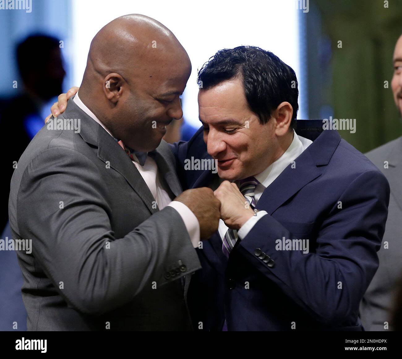 Assemblyman Anthony Rendon of Lakewood, right, gets a fist-bump from ...