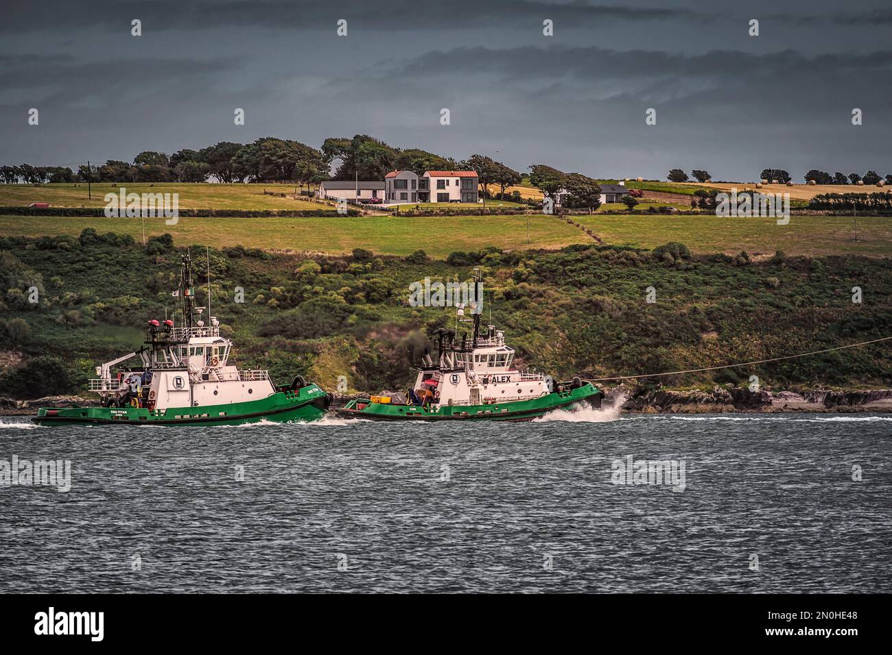 Cork Harbour tug vessels “Alex” and “Titan” escort cargo vessel which ...