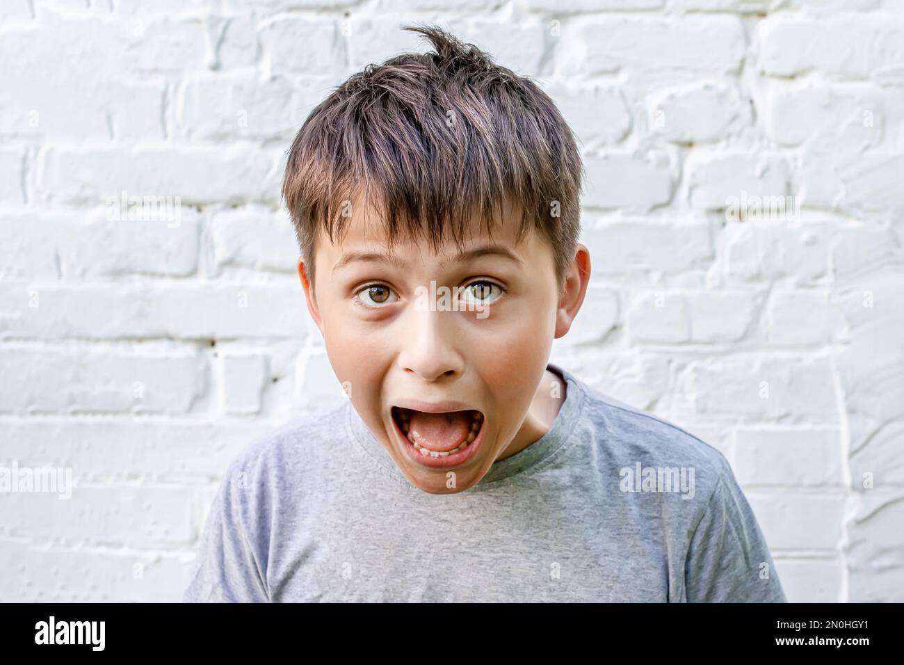 screaming Angry boy teenager with his mouth wide open and with open ...