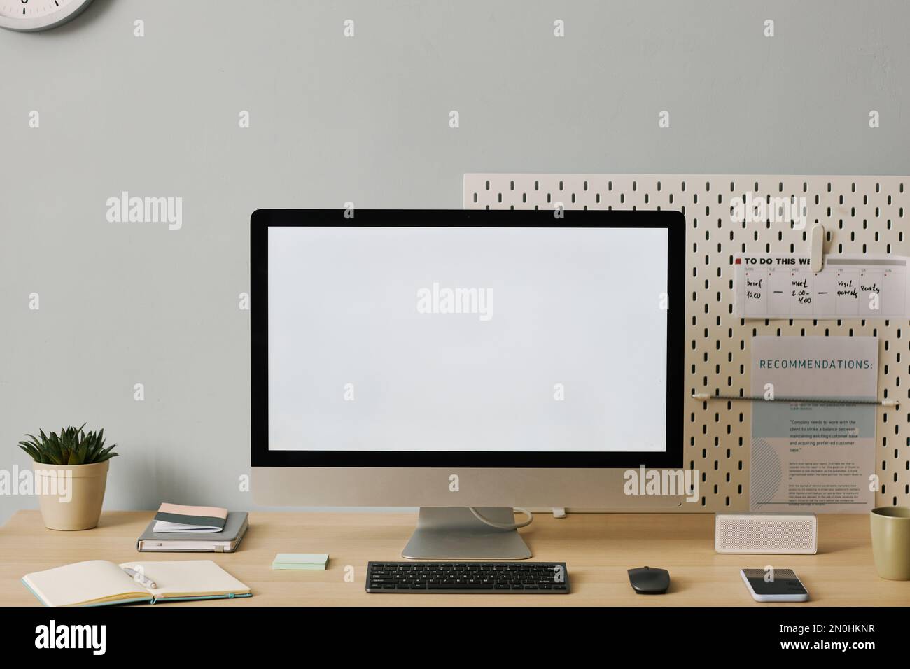 Front view background image of computer with blank white screen on desk ...