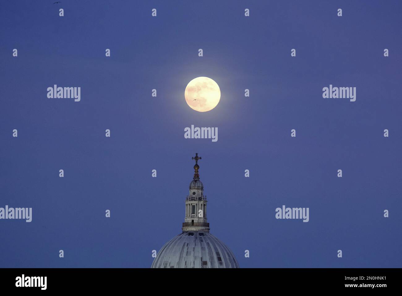 London, UK. 5th February, 2023. The full Snow Moon rises behind St Paul ...