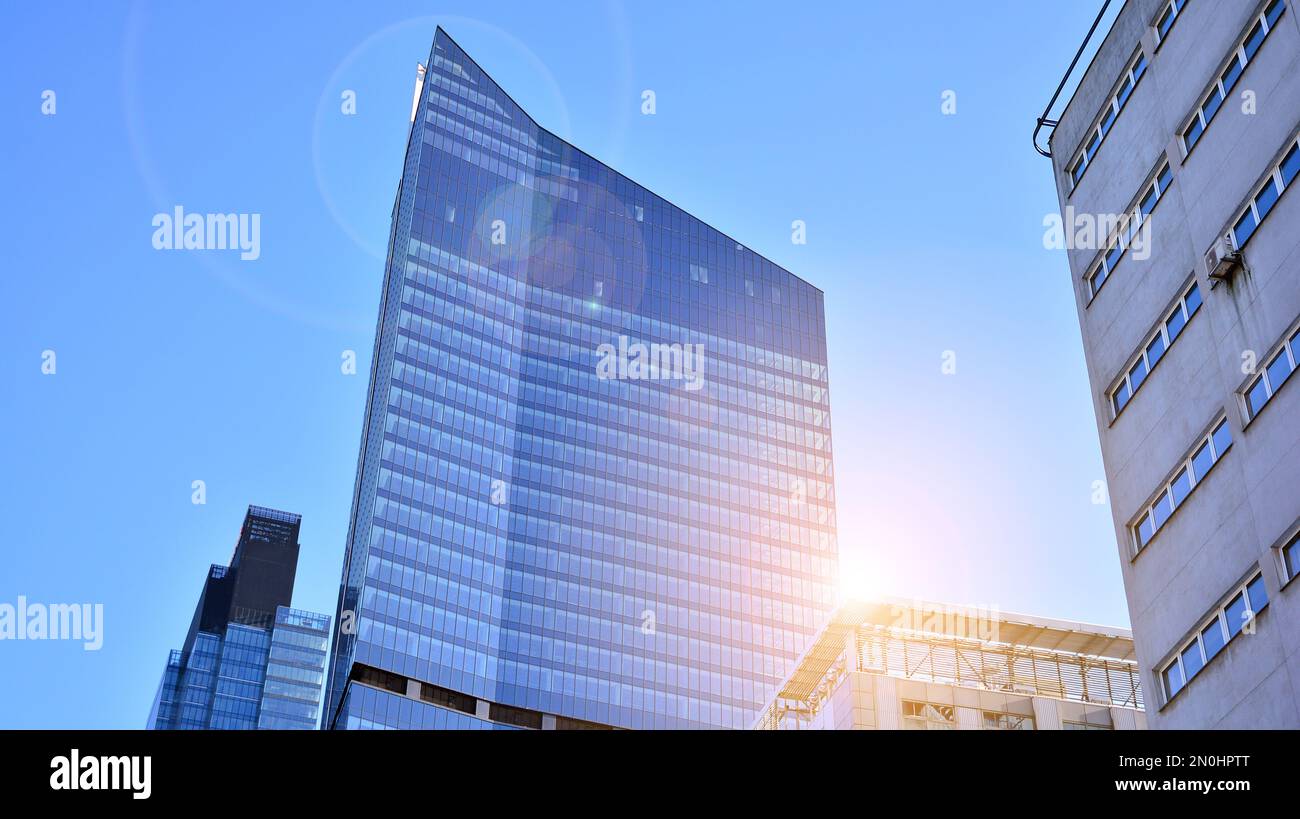 Office building, details of blue glass wall and sun reflections Stock ...