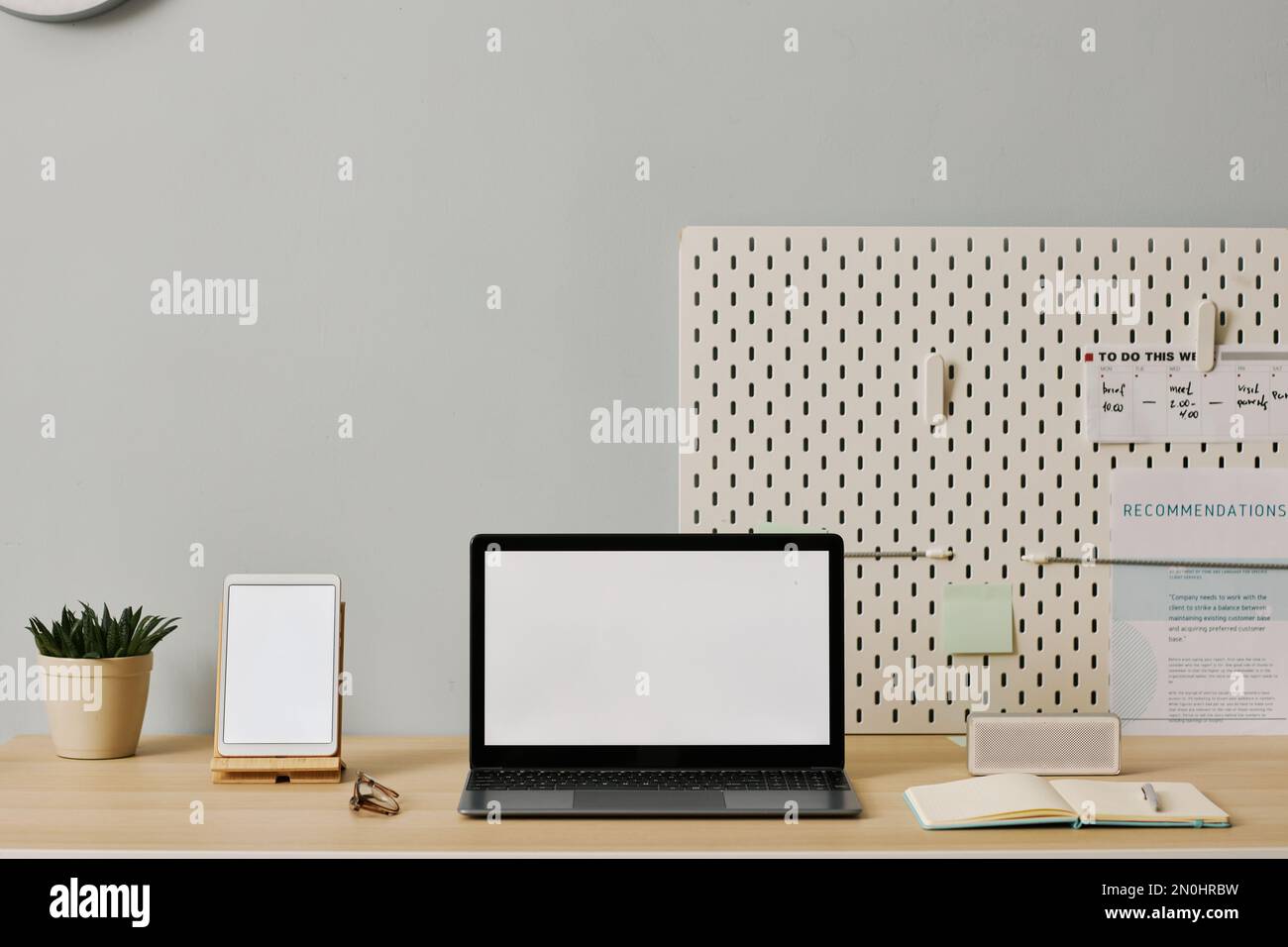 Minimal office setup with laptop screen mockup on desk, copy space ...