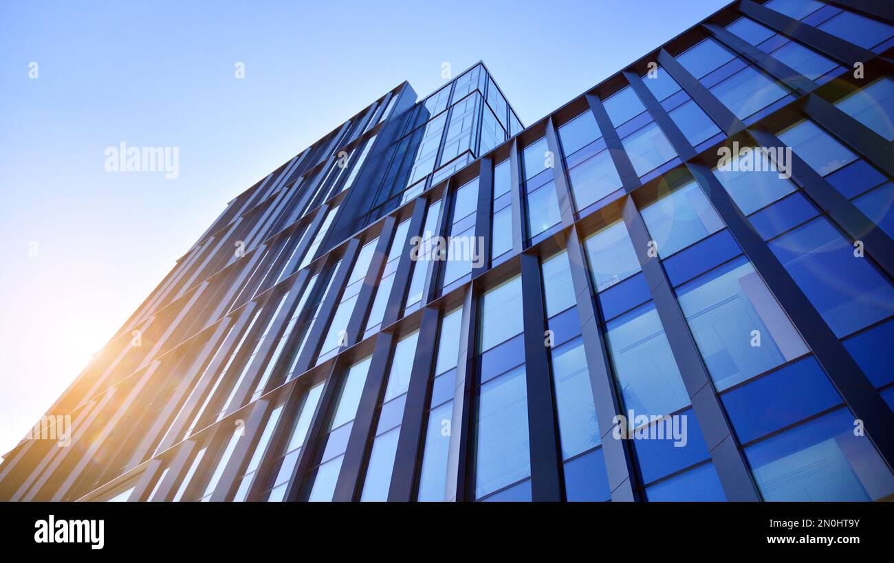 Office building, details of blue glass wall and sun reflections Stock ...