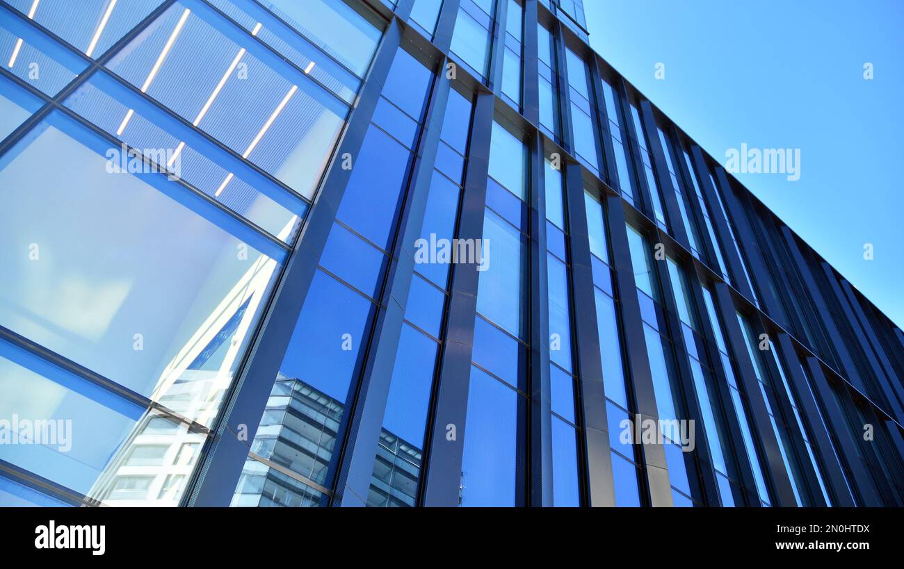 Office building, details of blue glass wall and sun reflections Stock ...