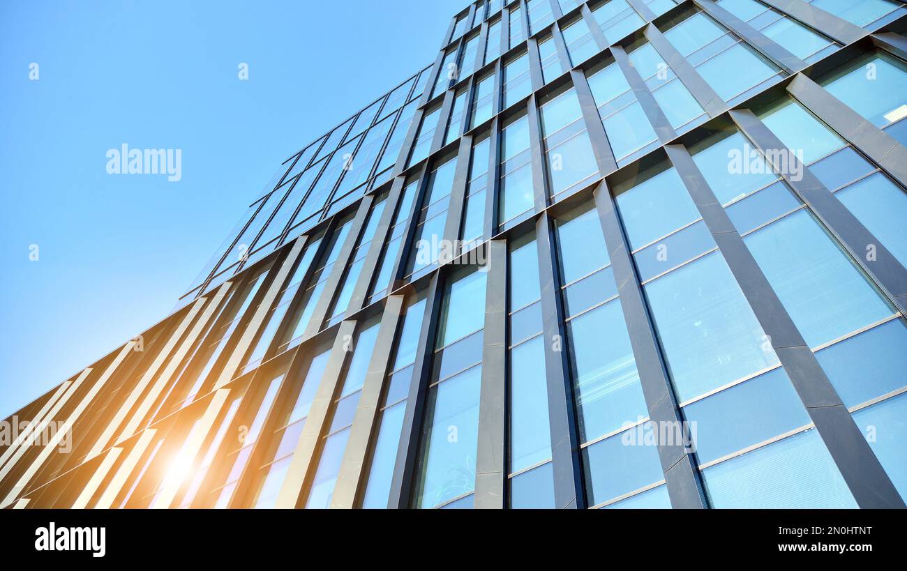 Office building, details of blue glass wall and sun reflections Stock ...