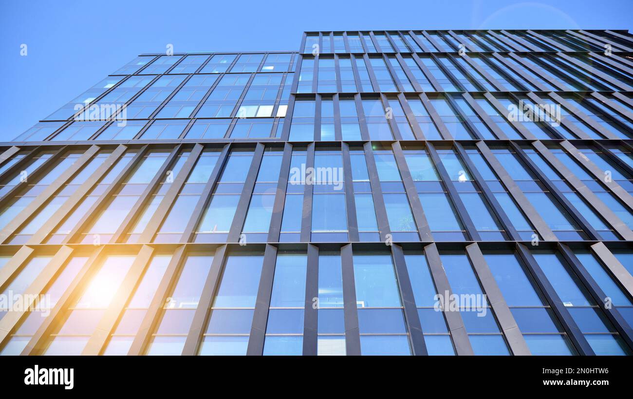 Office building, details of blue glass wall and sun reflections Stock ...