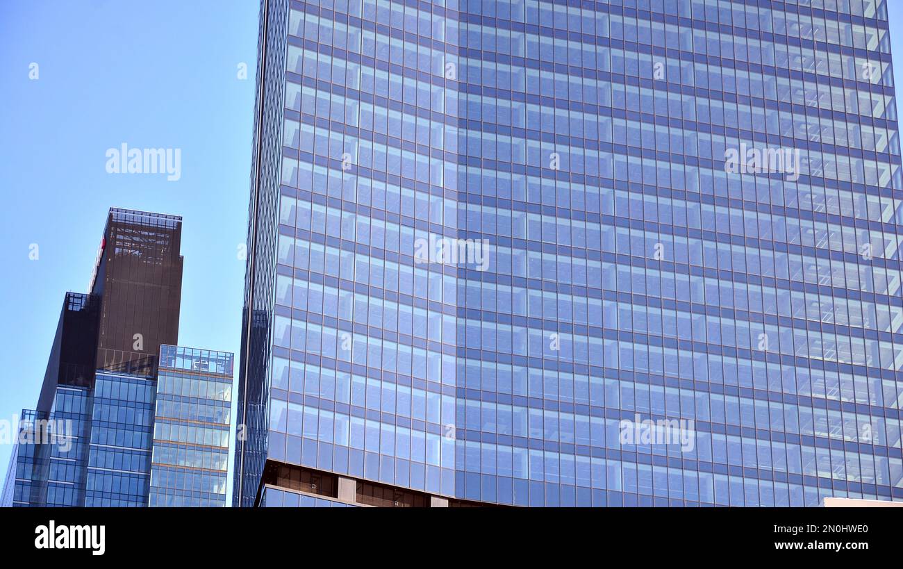 Blue curtain wall made of toned glass and steel constructions under ...