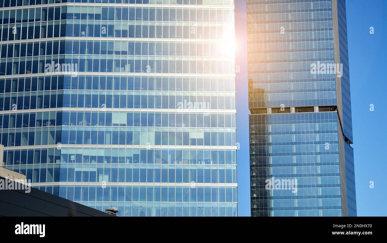 Blue curtain wall made of toned glass and steel constructions under ...
