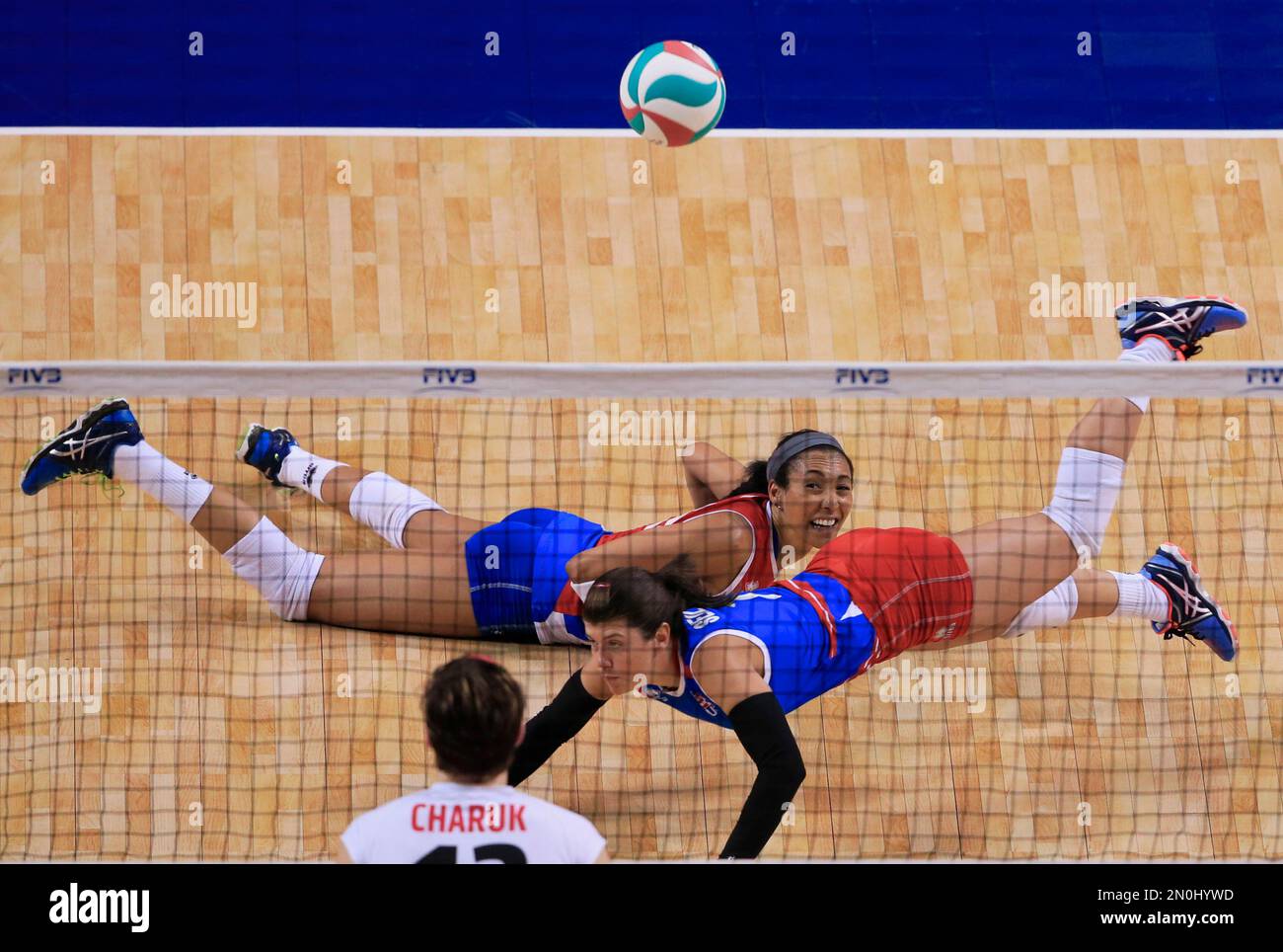 Puerto Rico's Aurea Cruz, , top, and Debora Seilhamer (1) leap for the ...