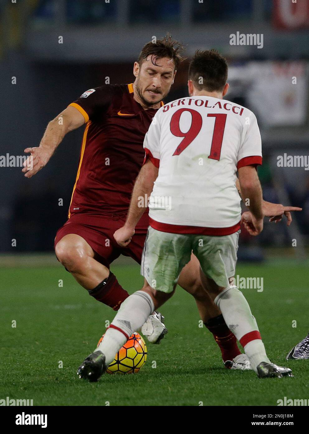 Roma’s Francesco Totti, left, controls the ball past AC Milan’s Andrea ...