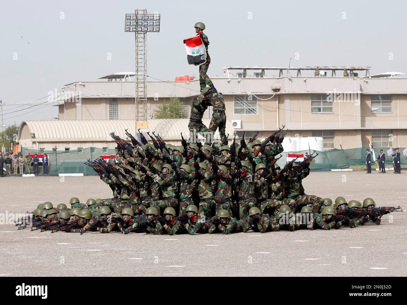 Iraqi federal police officers demonstrate their skills during a ...