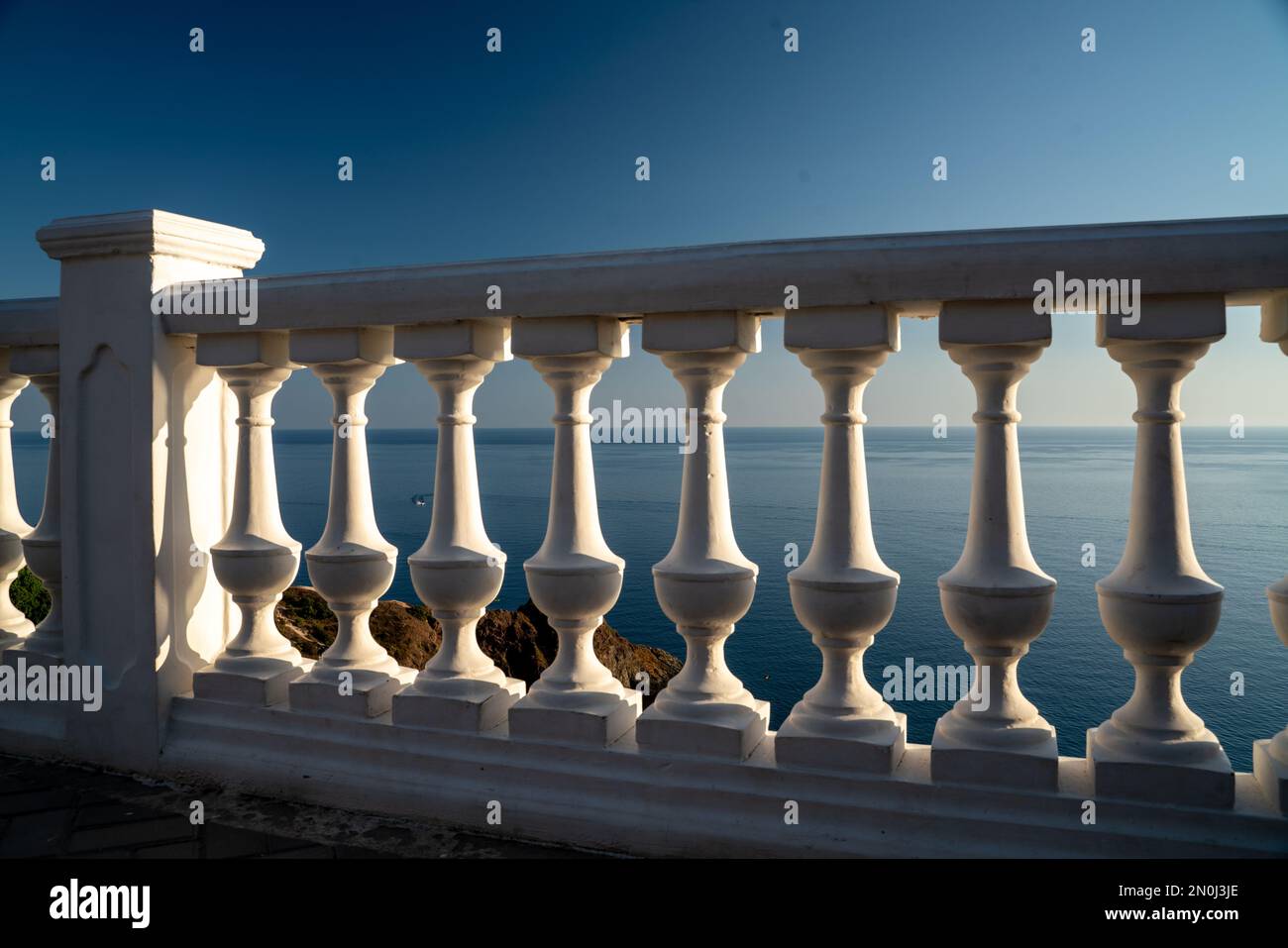 Classic balustrade on the embankment against the sea. White balcony ...
