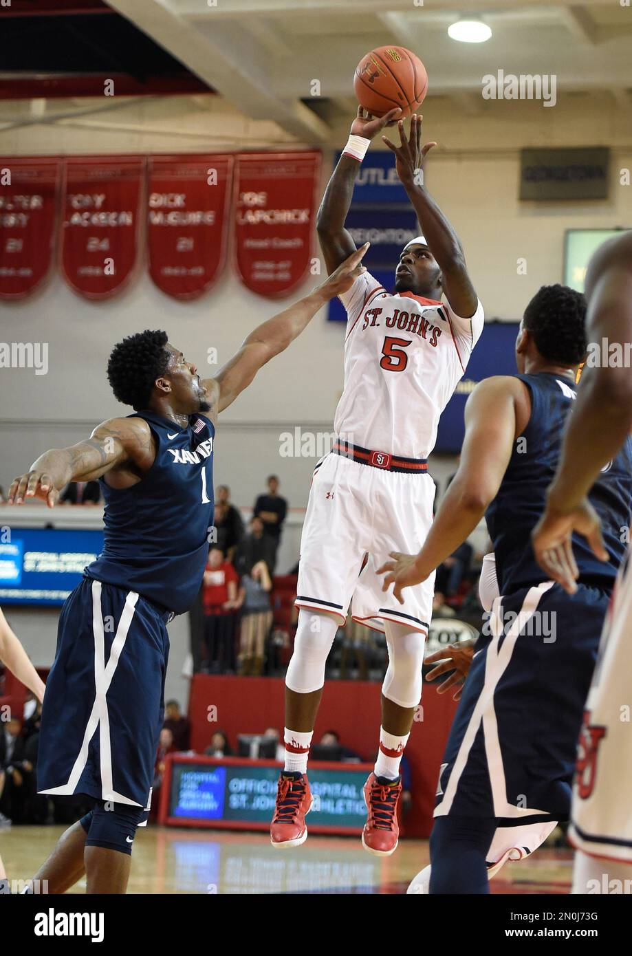 St. John's forward Durand Johnson (5) takes aim over Xavier forward ...