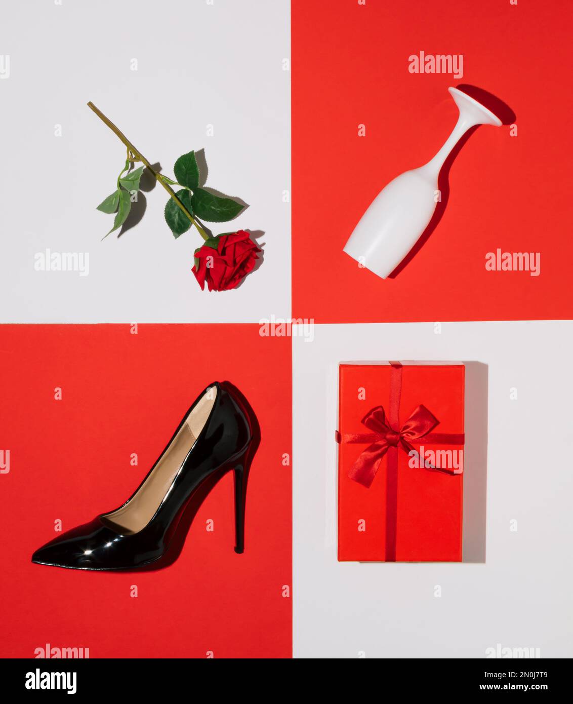 Elegant black woman's shoe, red rose flower, gift box and wineglass ...