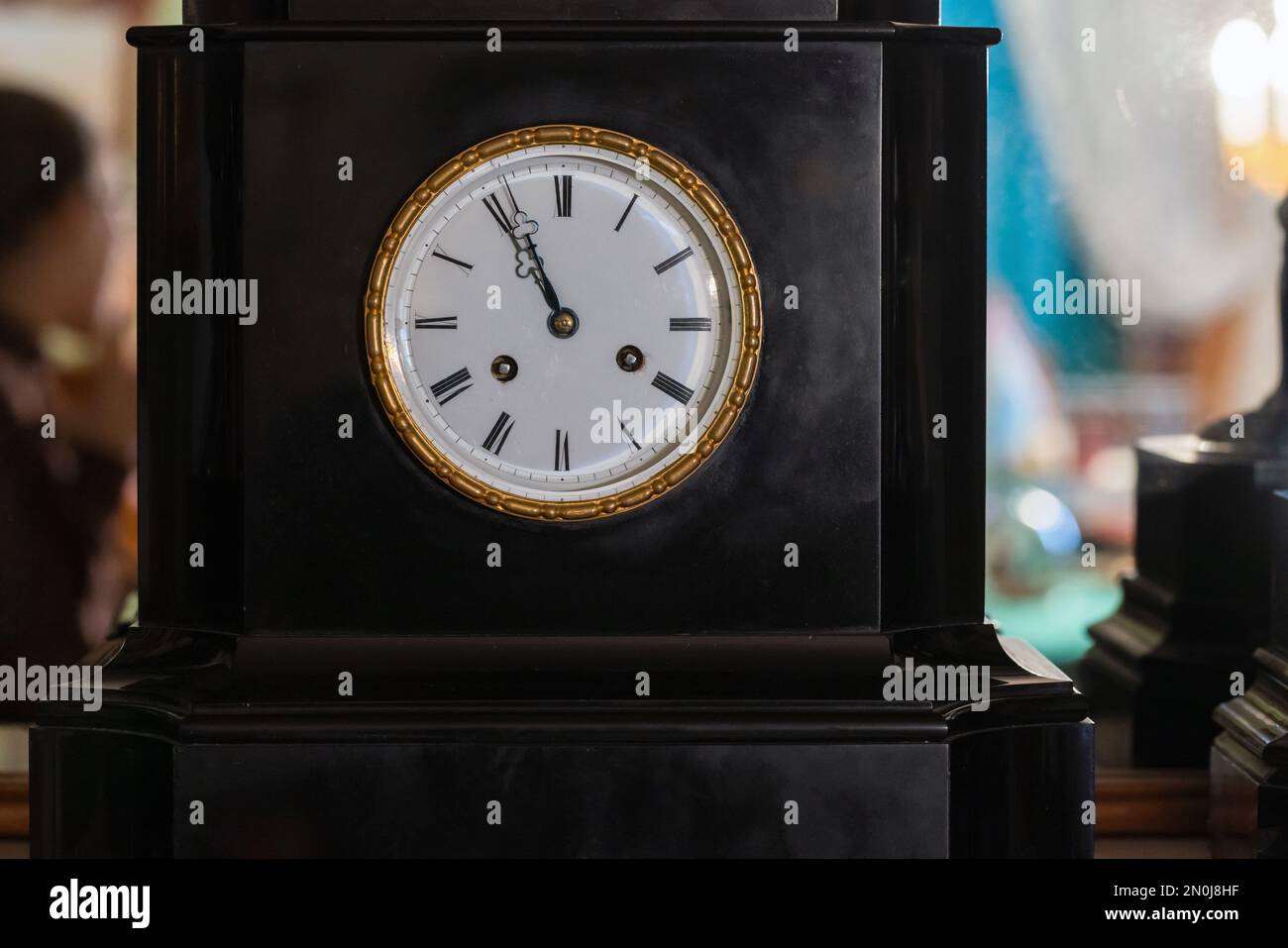 Deal of vintage table clock with roman numerals. Close up frontal photo ...