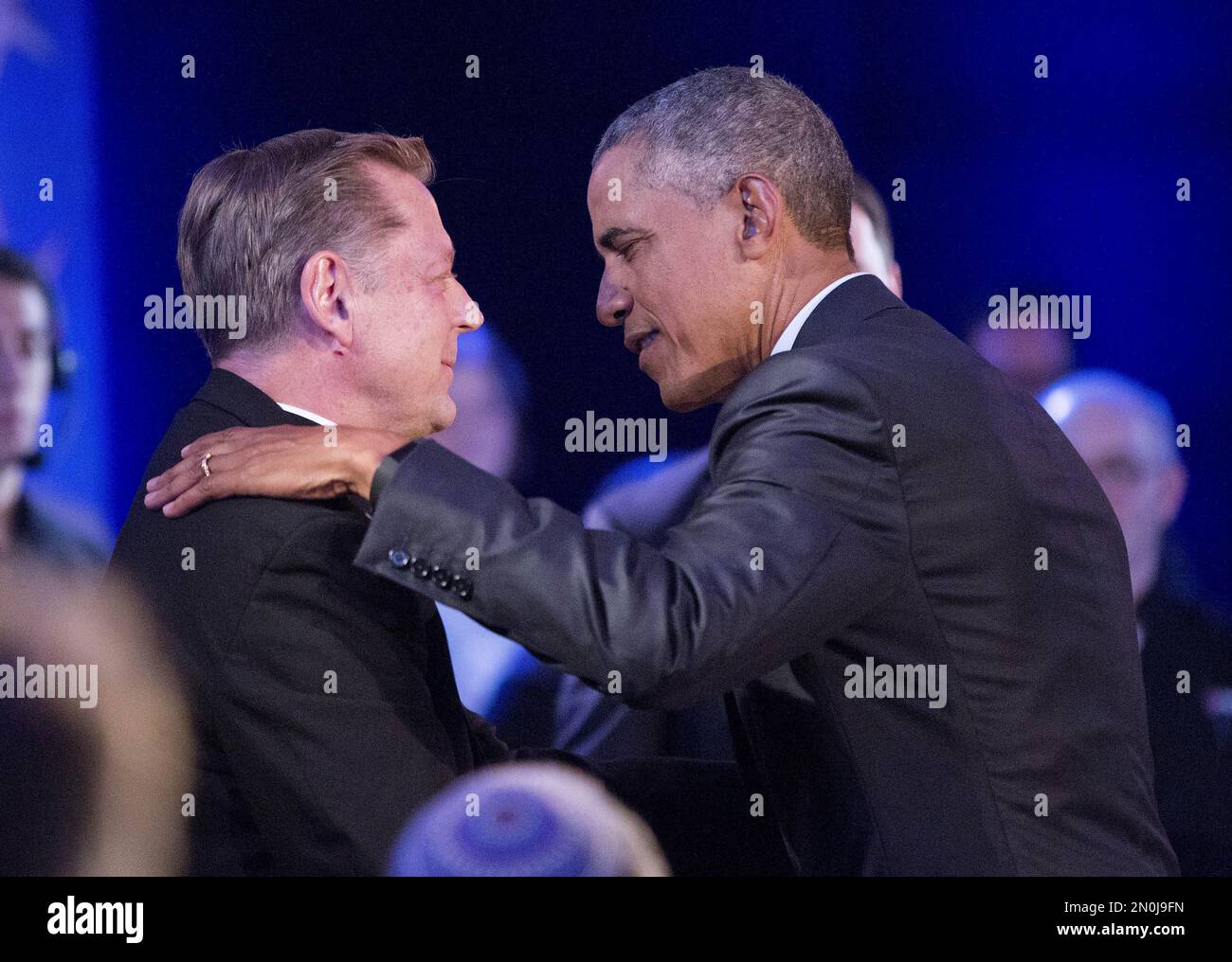 President Barack Obama, right, stops to greet Father Michael Pfleger ...