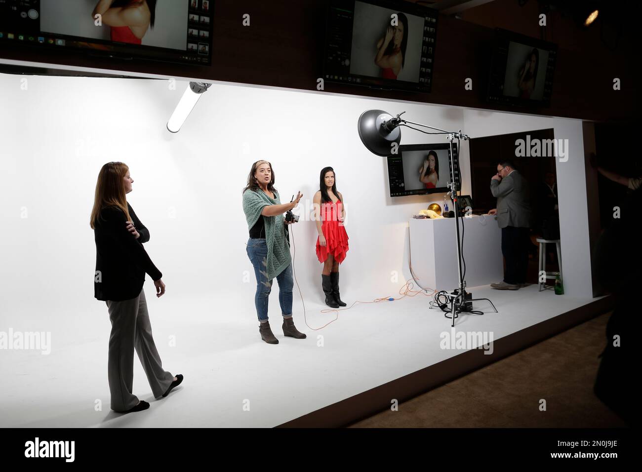 Photographer Me Ra Koh, center, talks as she shoots a portrait with the ...
