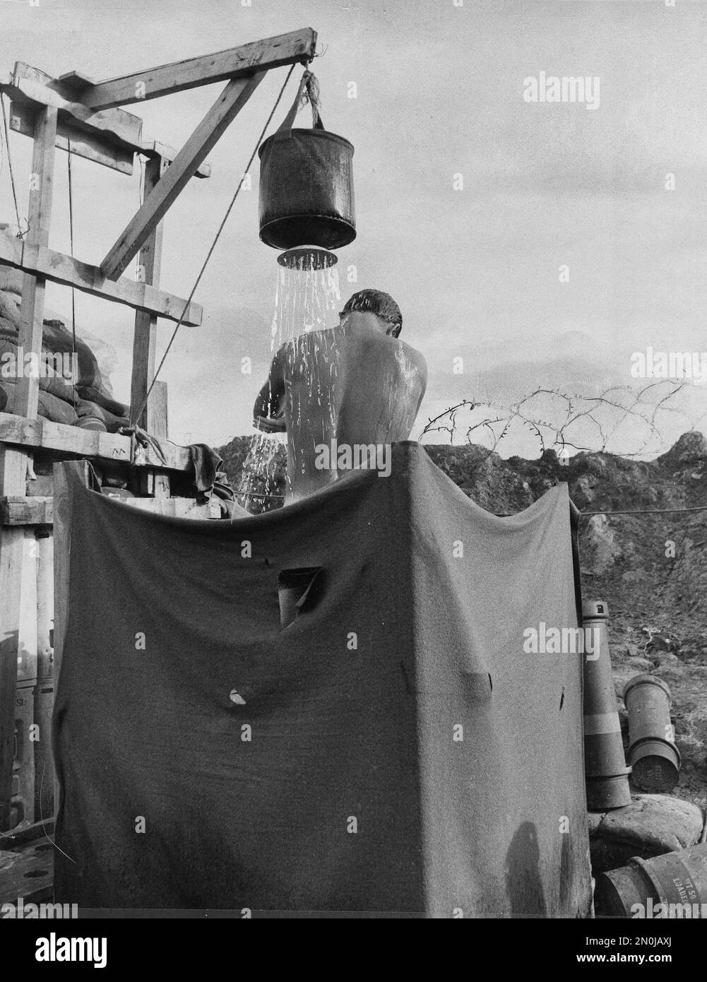 An American cavalryman uses an outdoor shower at Firebase Pace, near ...