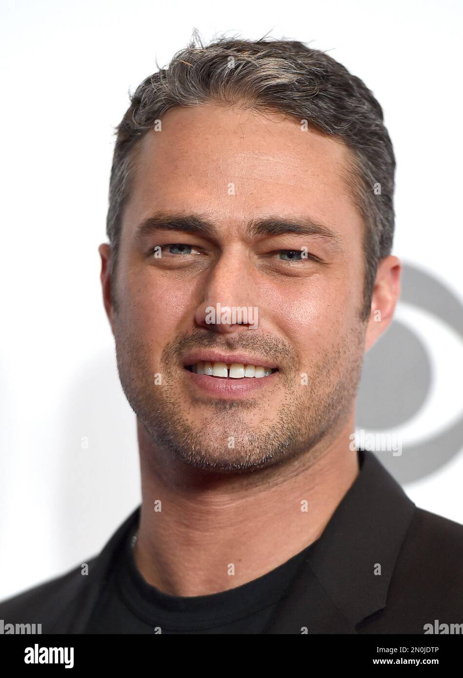 Taylor Kinney poses in the press room with the award for favorite ...