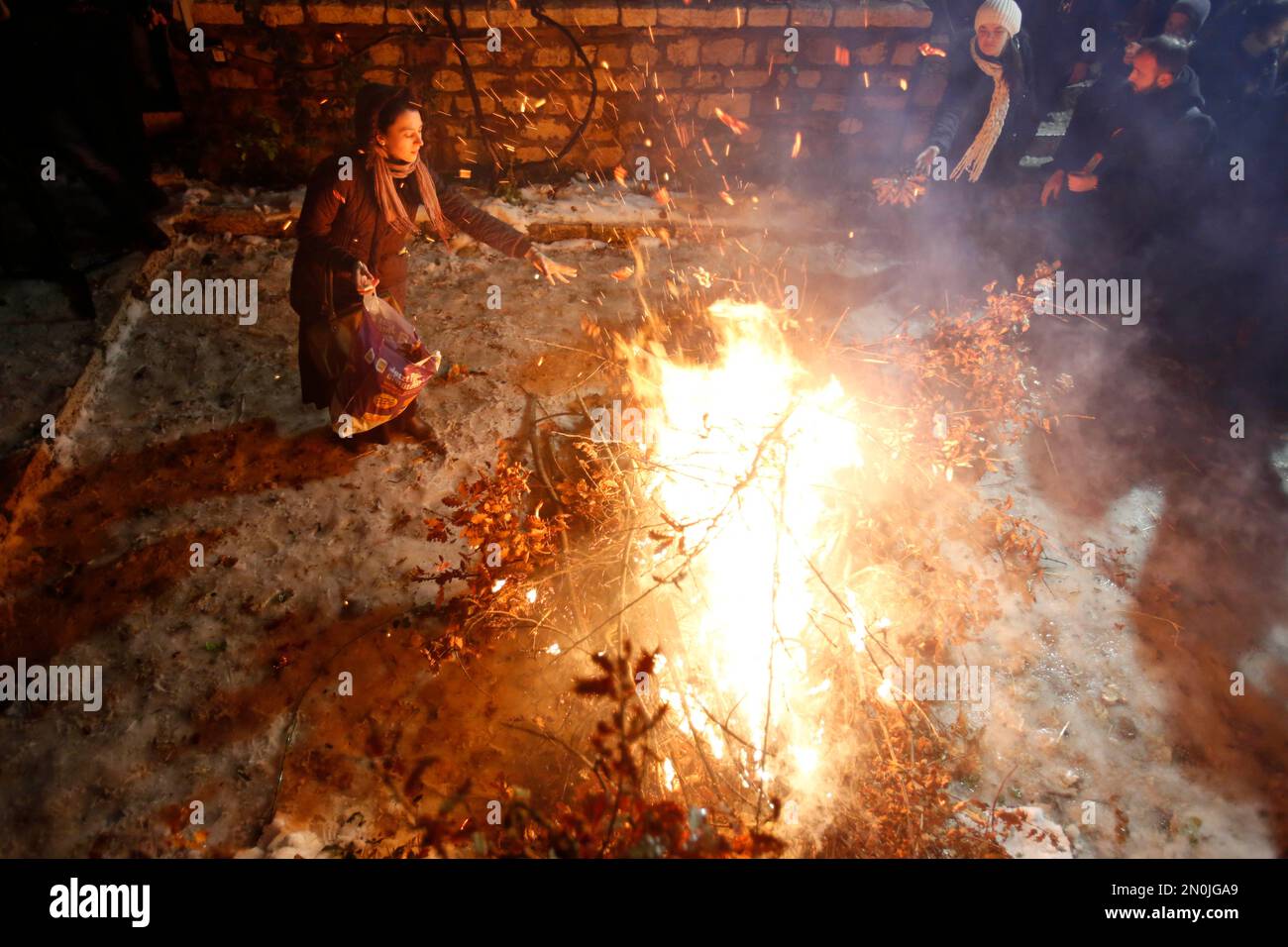 Bosnian Serb people gather around a fire of dried oak branches, the ...