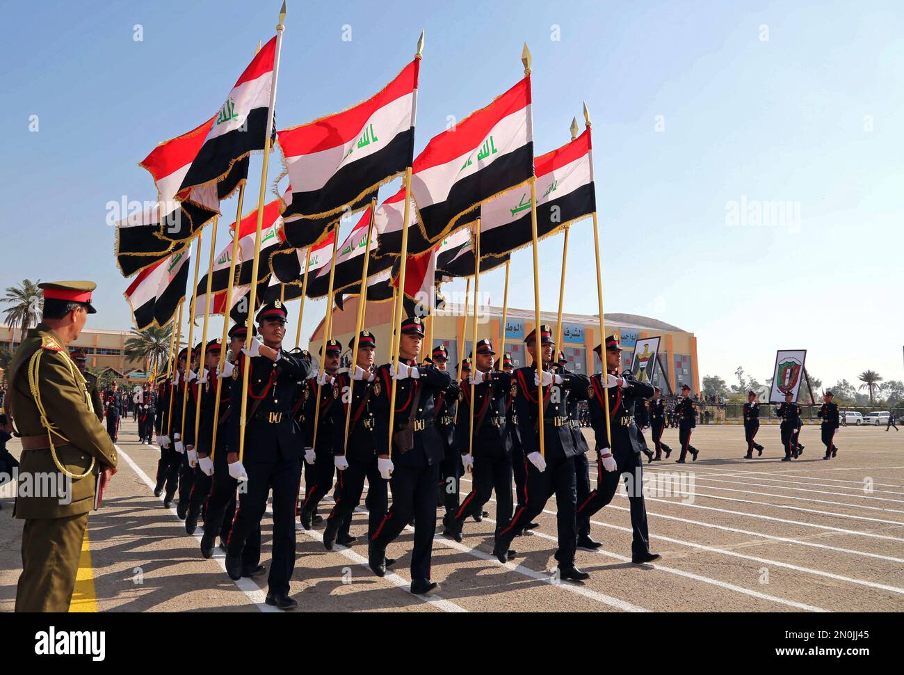 Soldiers march with Iraqi national flags during Army Day celebrations ...
