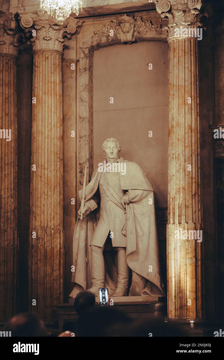 A vertical shot of the sculpture of standing man captures grace and ...
