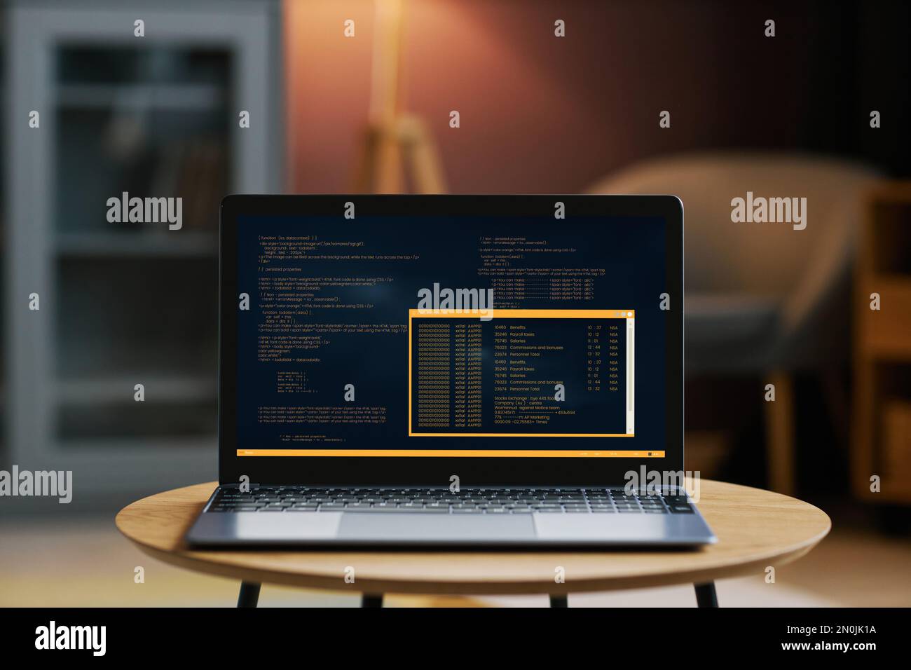 Background image of open laptop with code on screen in dim home ...