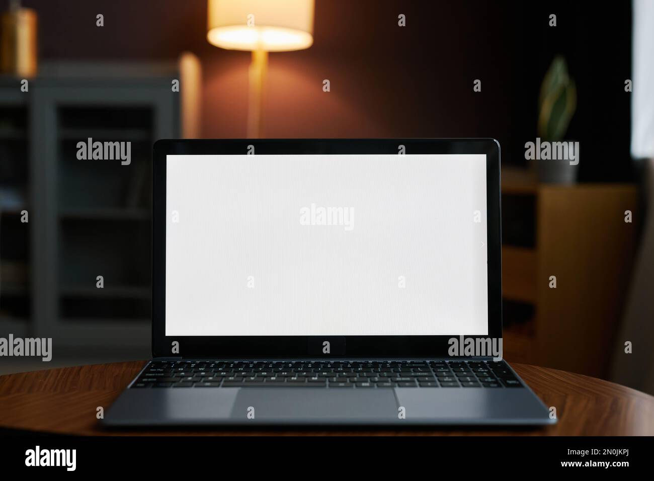 Background image of open laptop with white screen mock up in dark Stock ...