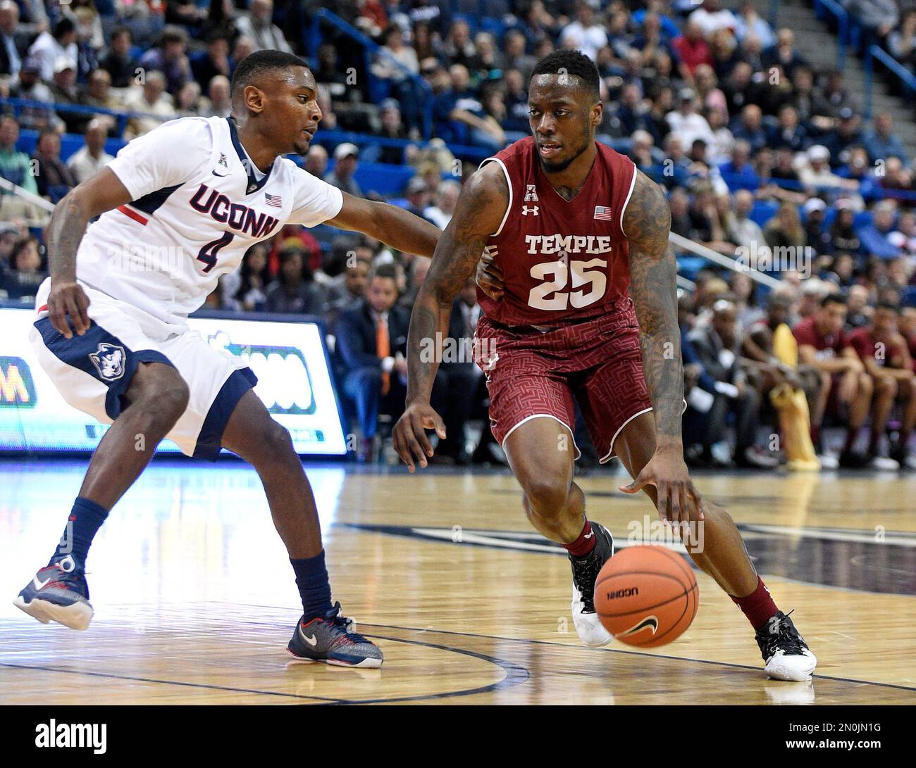Temple's Quenton DeCosey (25) drives past Connecticut's Sterling Gibbs ...