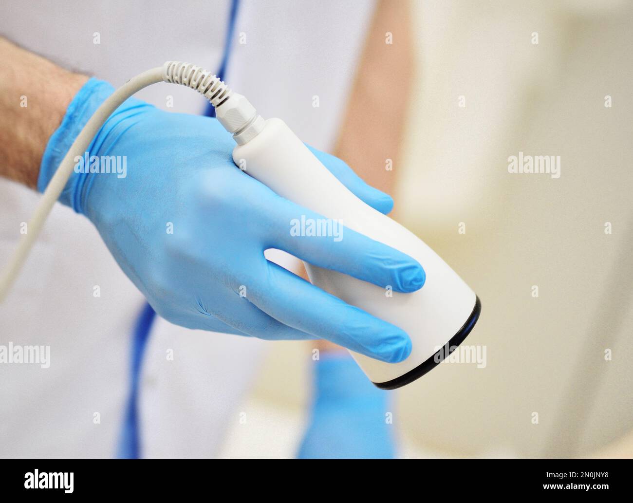 cosmetologist holds an ultrasound cavitation device in his hands - a ...