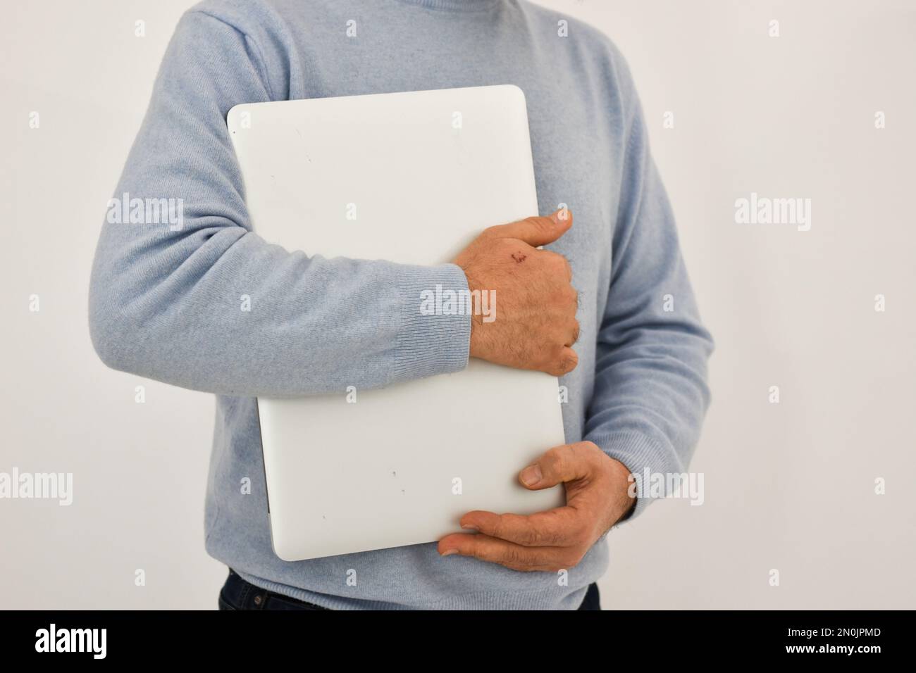 Adult man holding laptop computer isolated on white background Stock ...