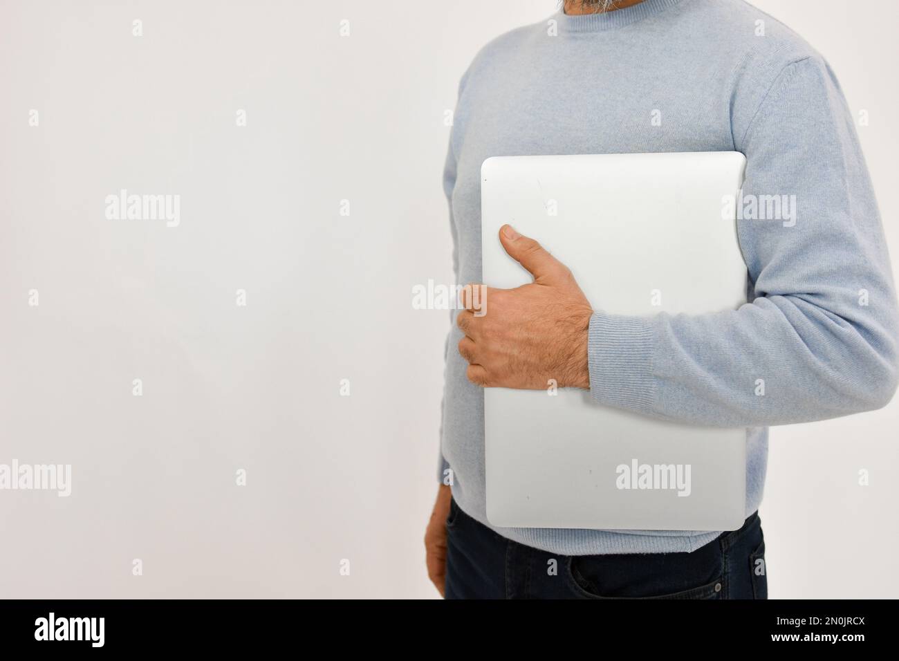 Adult man holding laptop computer isolated on white background Stock ...