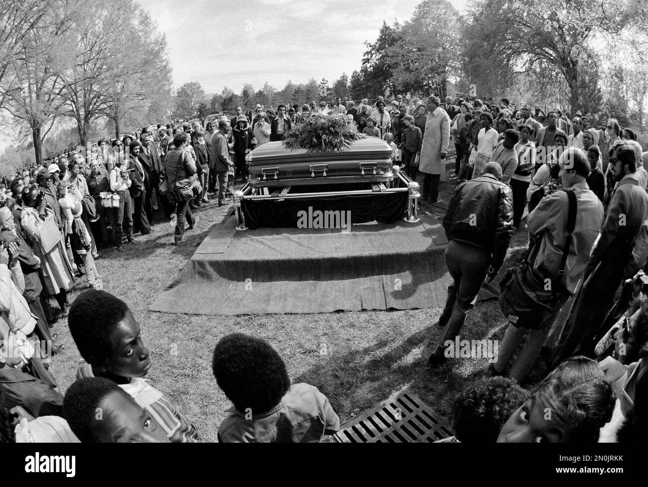 A crowd of mourners surrounds the casket of boxing great Joe Louis ...