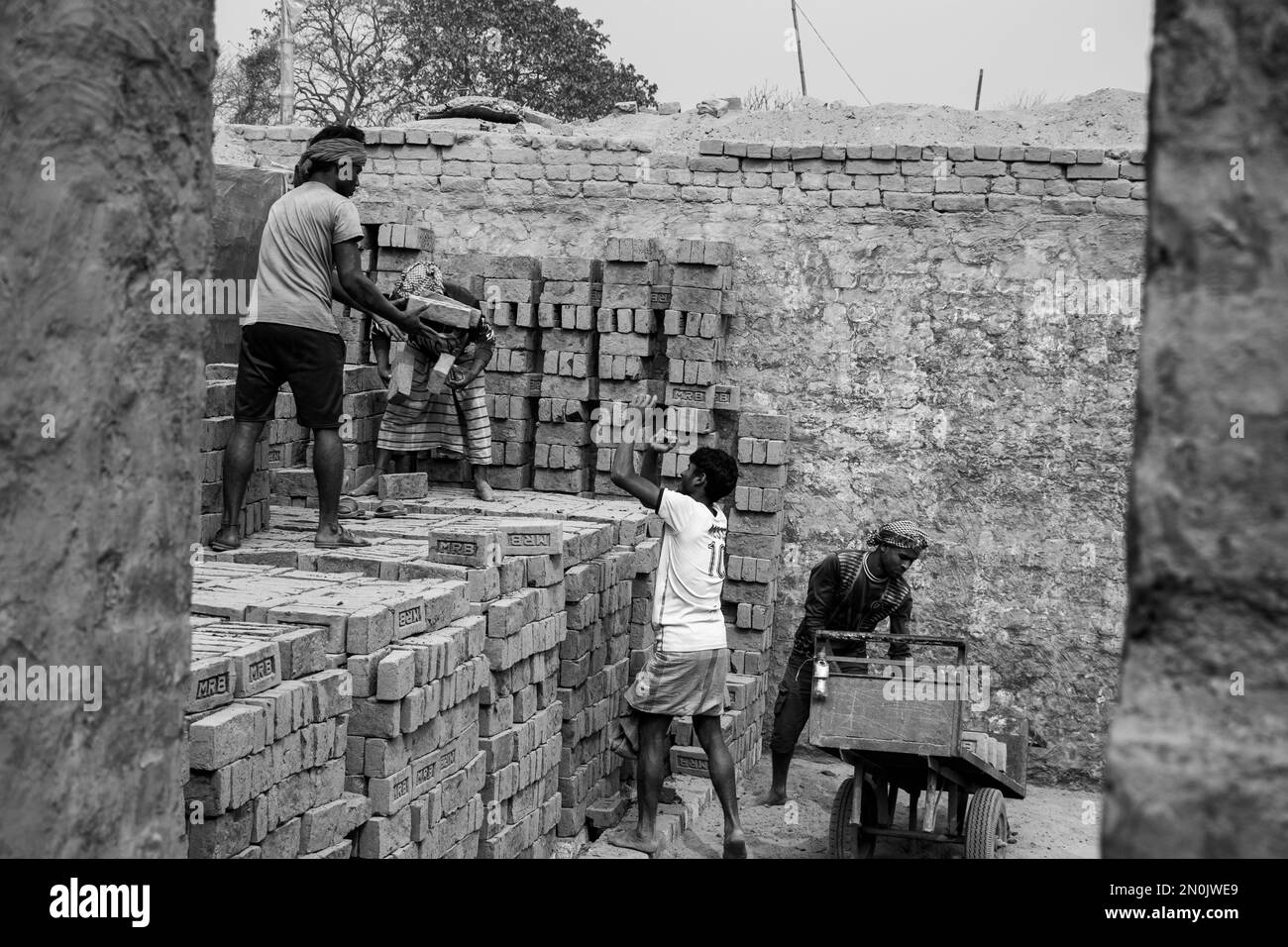 People are working hard in the brick field. This image was taken from ...