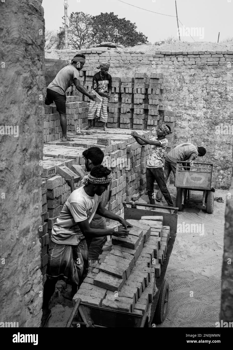 People are working hard in the brick field. This image was taken from ...