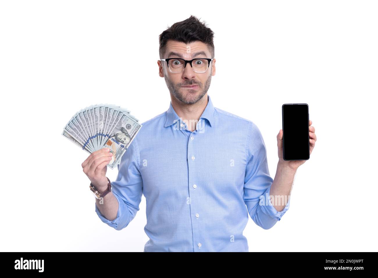 Doubtful guy showing cash money and smartphone. Cash payment or ...