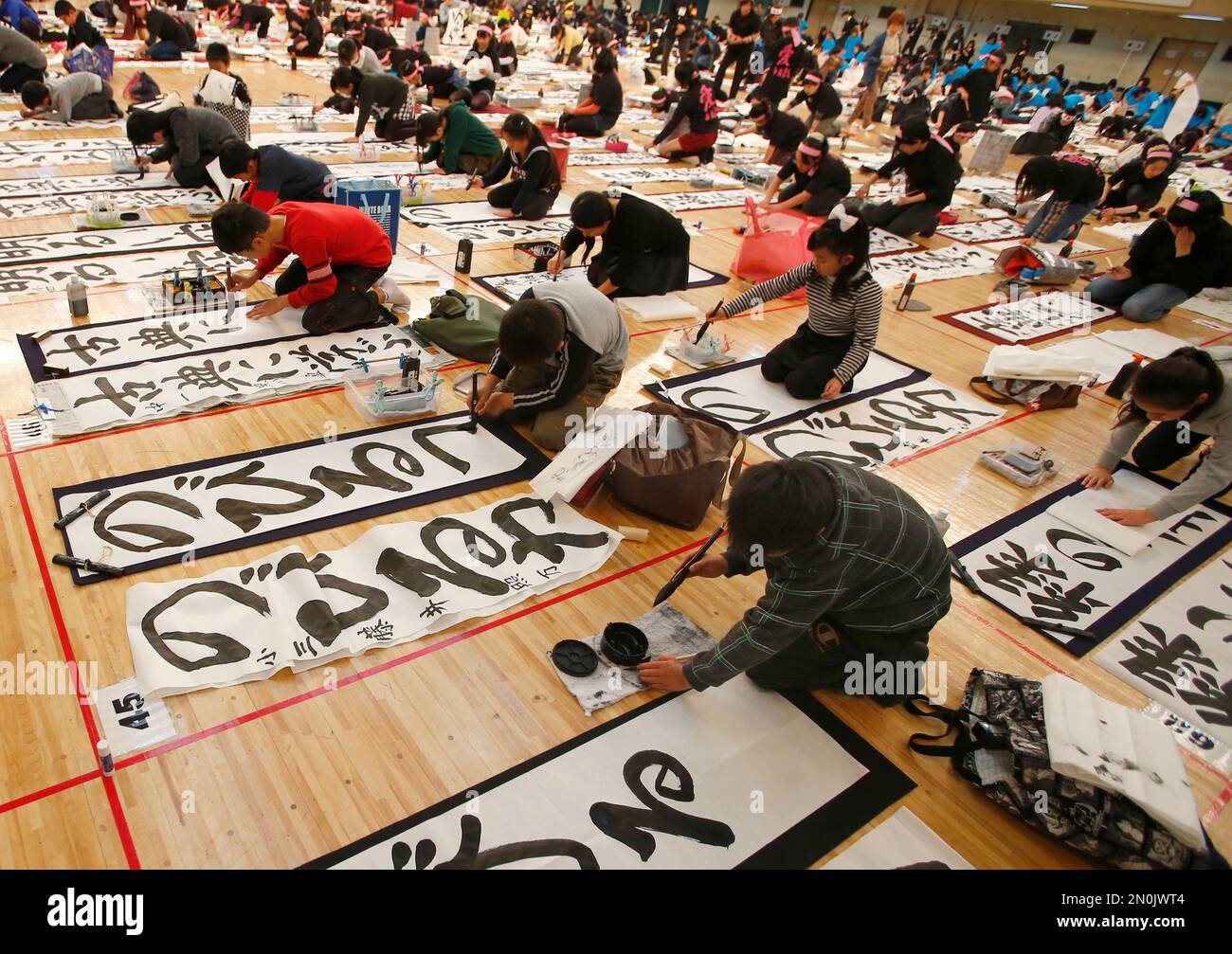Participants write traditional Japanese calligraphy during the annual ...