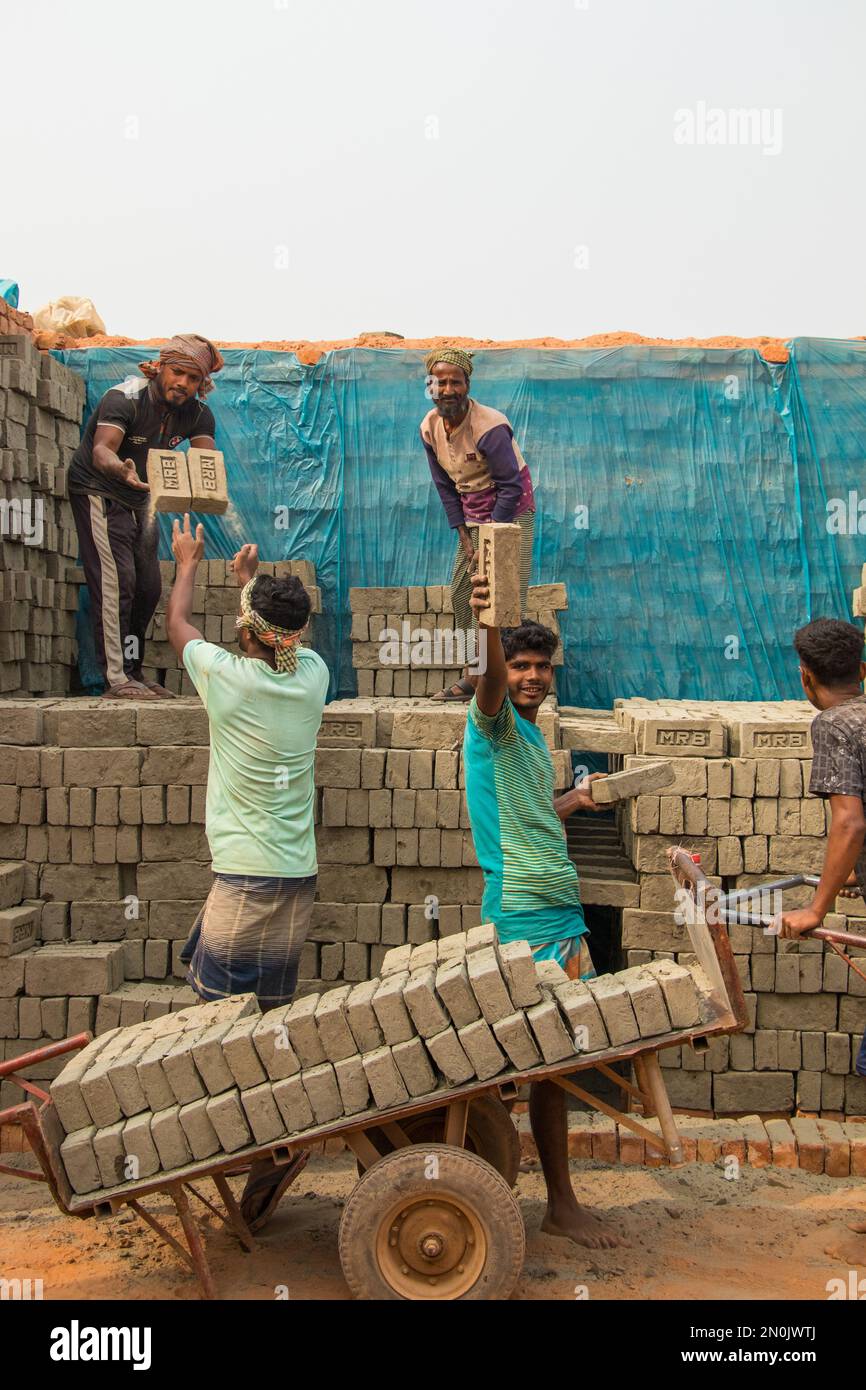 People are working hard in the brick field. This image was taken from ...
