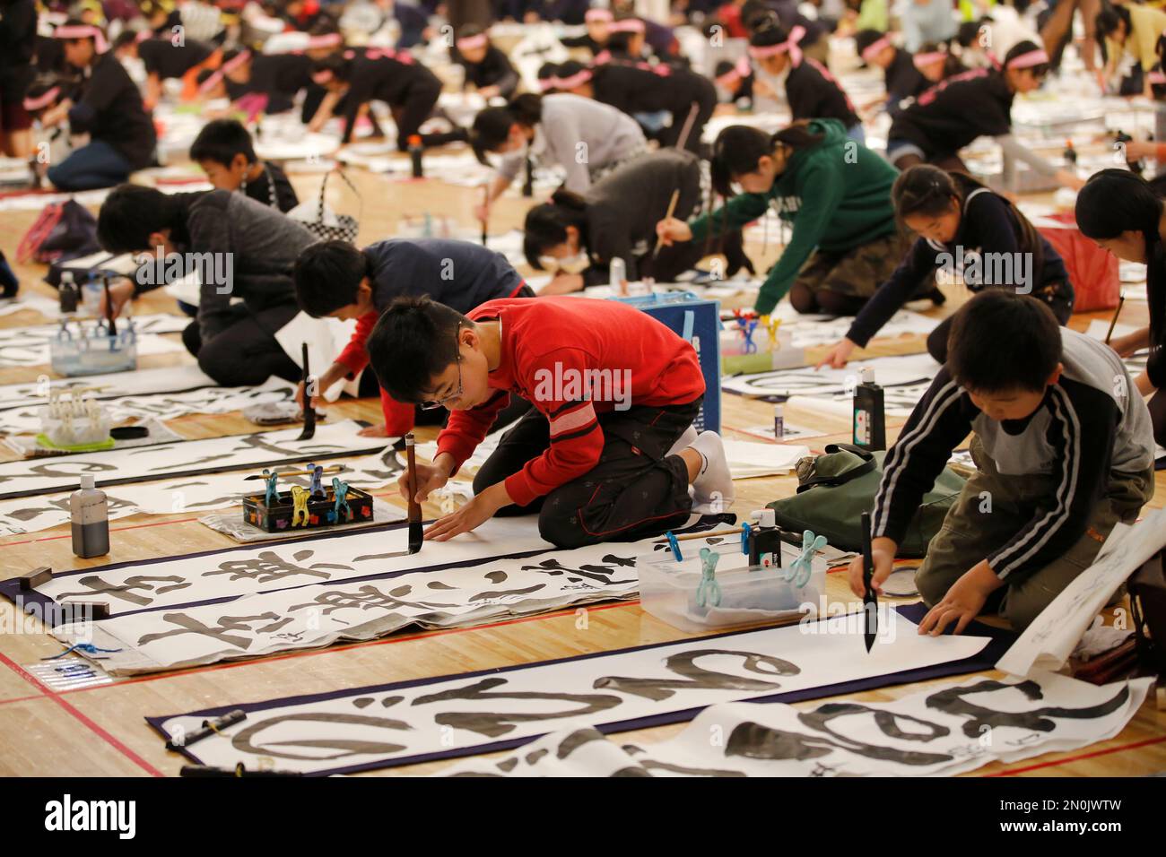 Participants write traditional Japanese calligraphy during an annual ...