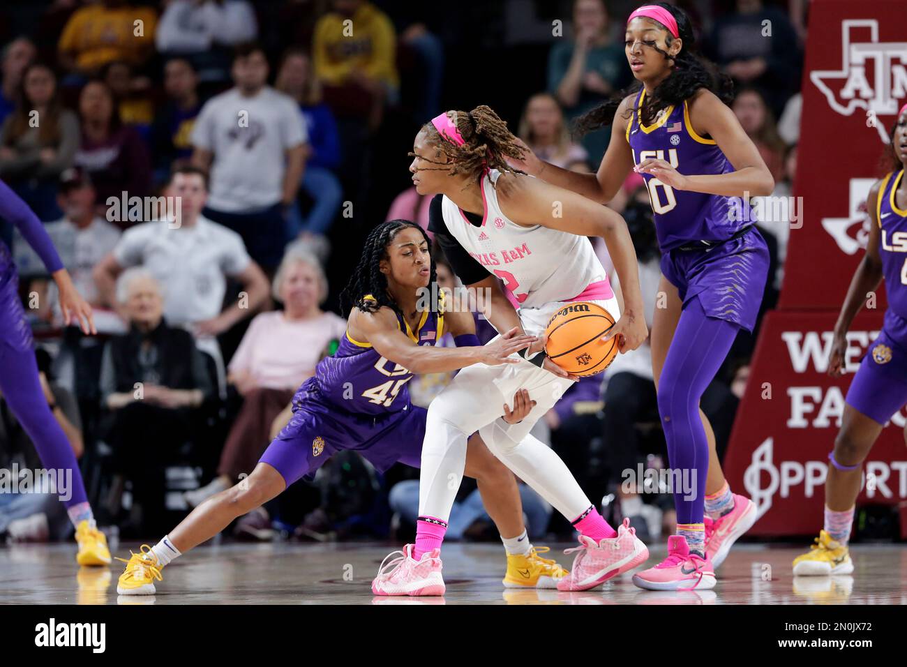 Texas A&M forward Janiah Barker, center, protects the ball as LSU guard ...