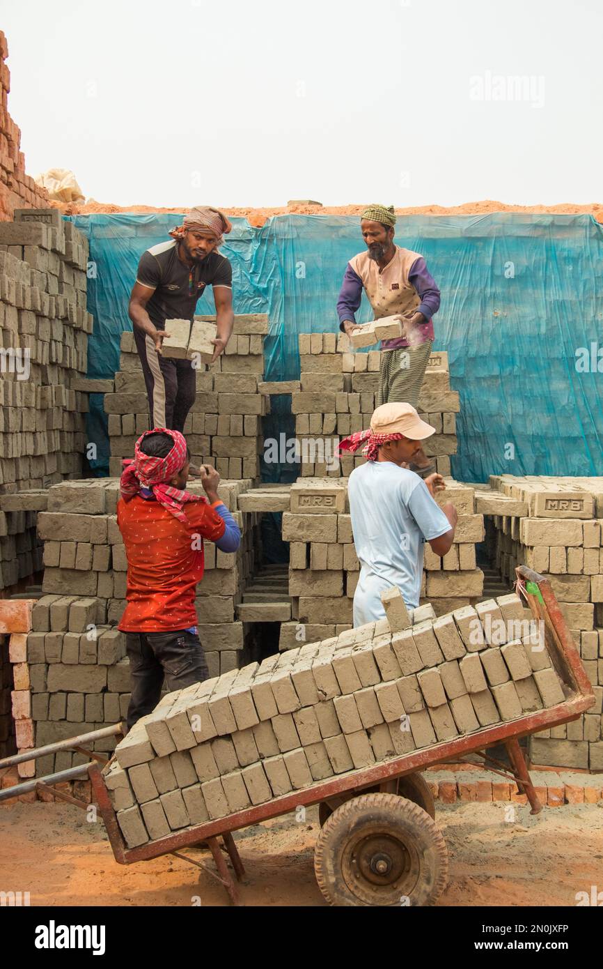 People are working hard in the brick field. This image was taken from ...