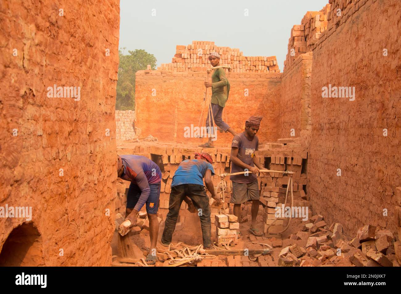 People are working hard in the brick field. This image was taken from ...